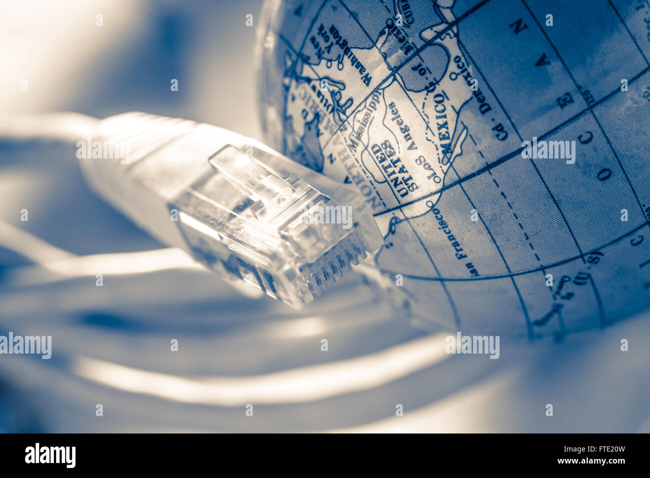 Ethernet cable for computer and globe in toning Stock Photo - Alamy