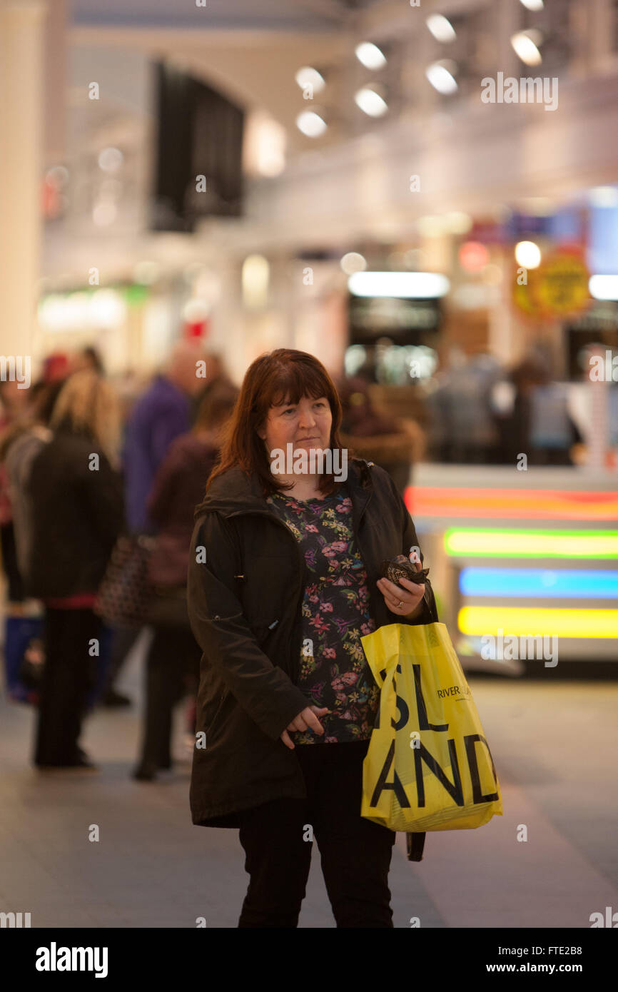 Shoppers shopping in The Centre shopping mall, in Livingston, Scotland ...