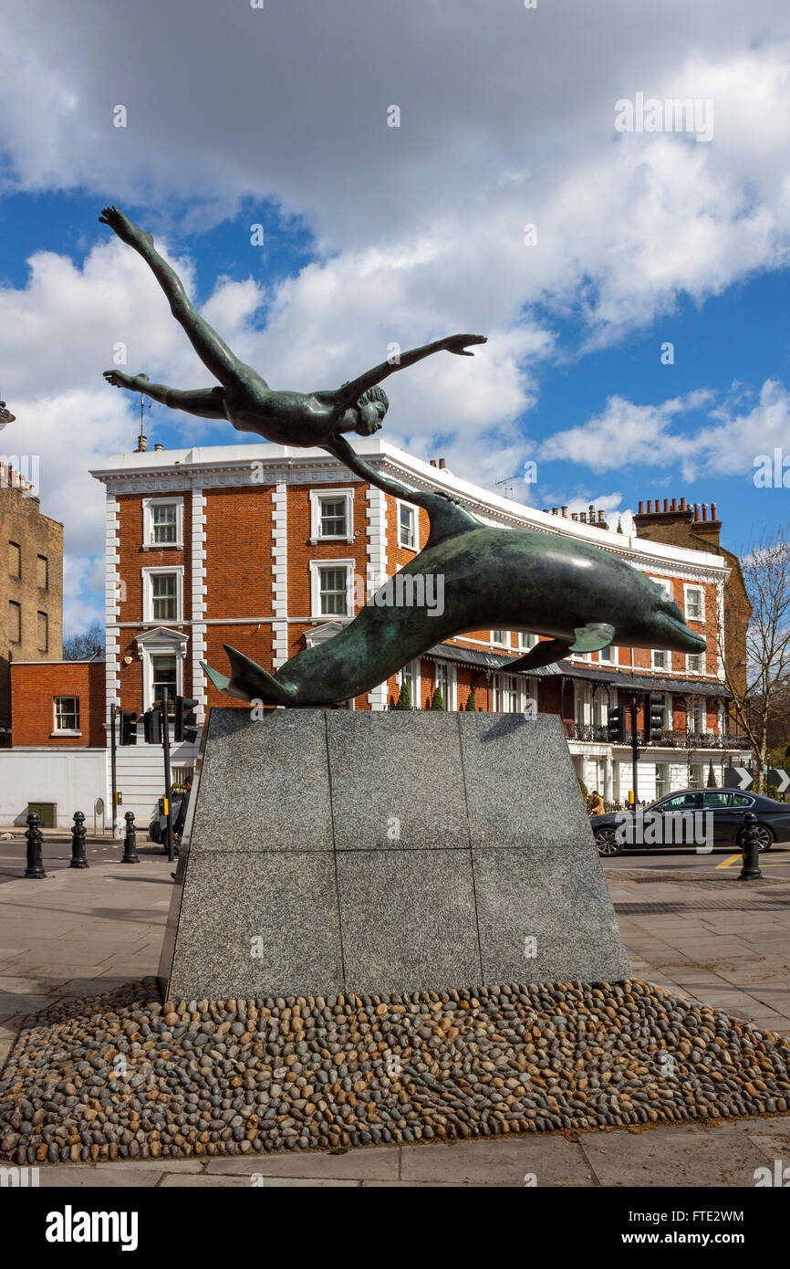 Dolphin and boy statue hi-res stock photography and images - Alamy