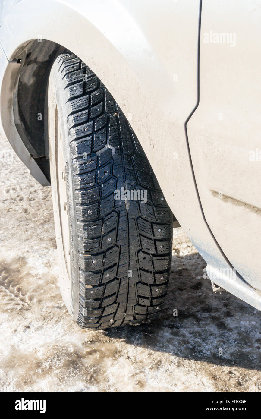 Car tyre with winter treads resting on dirty grey snow Stock Photo - Alamy