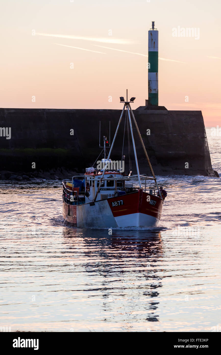 fishing boat coming into Aberystwyth harbour a sunset Stock Photo - Alamy