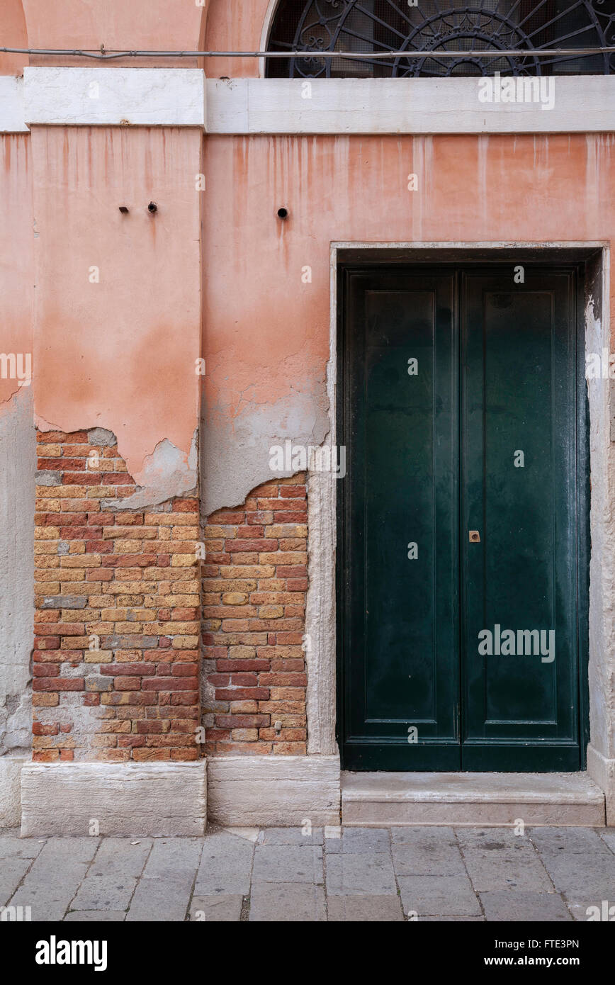 Frontage detail of a decaying building with crumbling pink painted ...