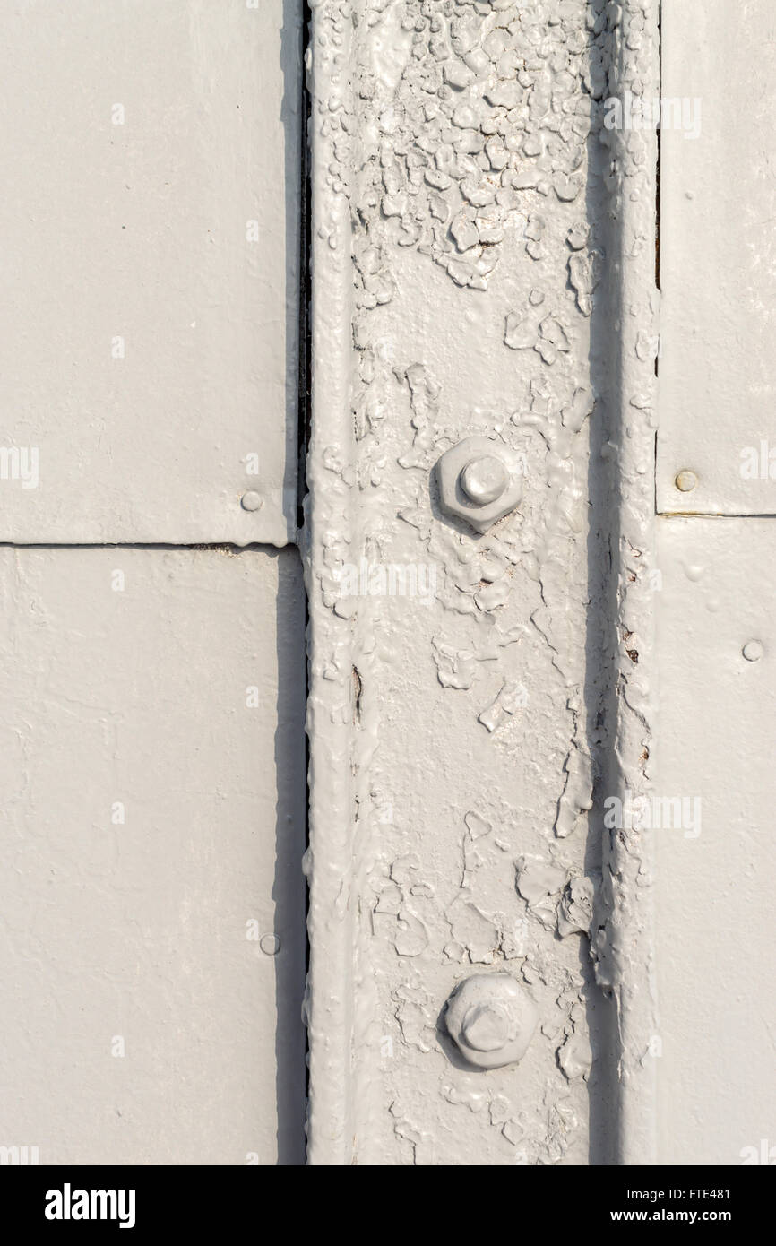 Close up architectural image of grey painted bolts used for securing ...