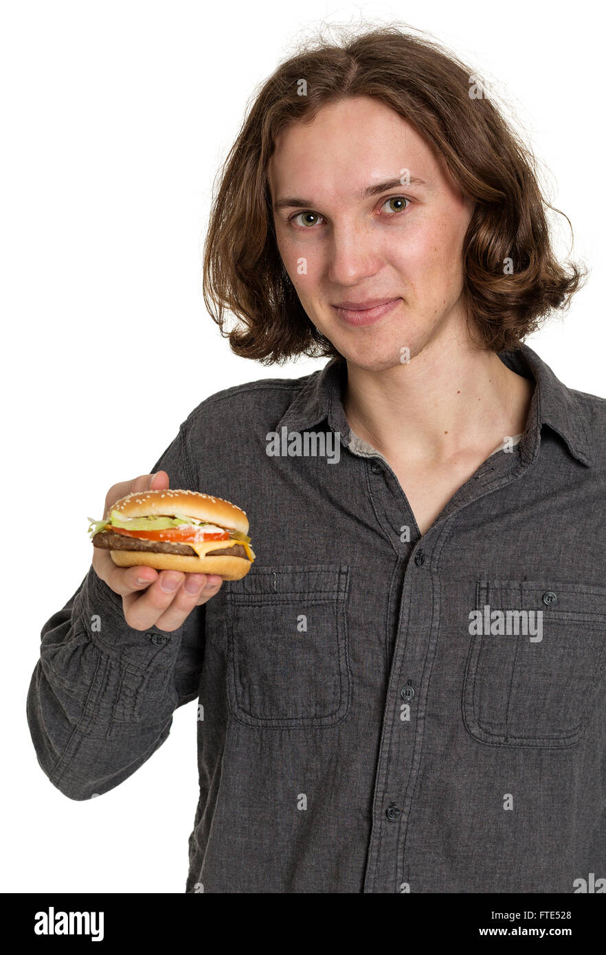 Young man eating a hamburger Stock Photo - Alamy
