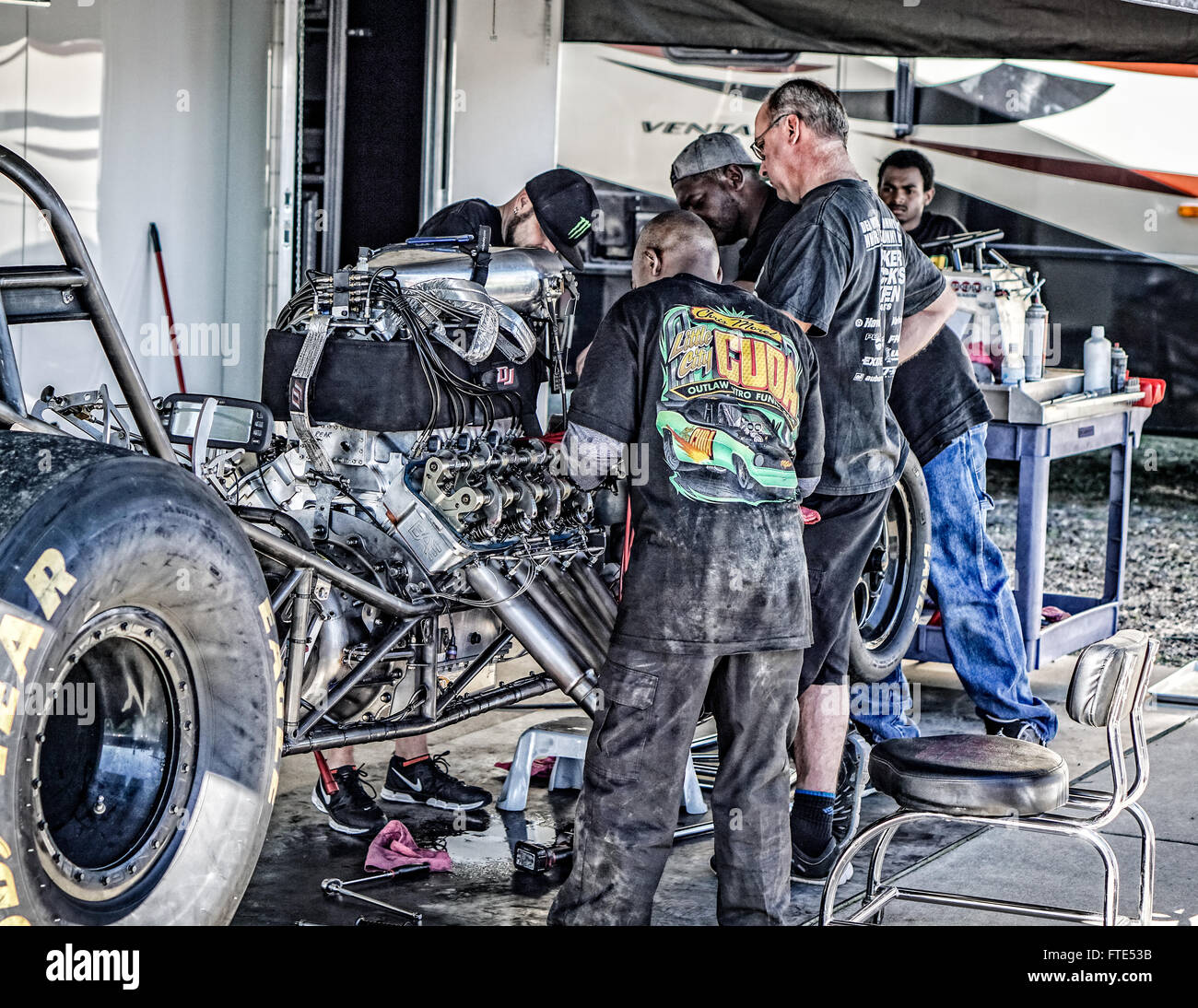 Redding California- Mechanics and crew work on the engine of a drag ...