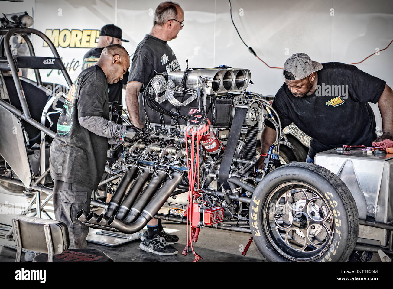 Redding California- Mechanics and crew work on the engine of a drag ...