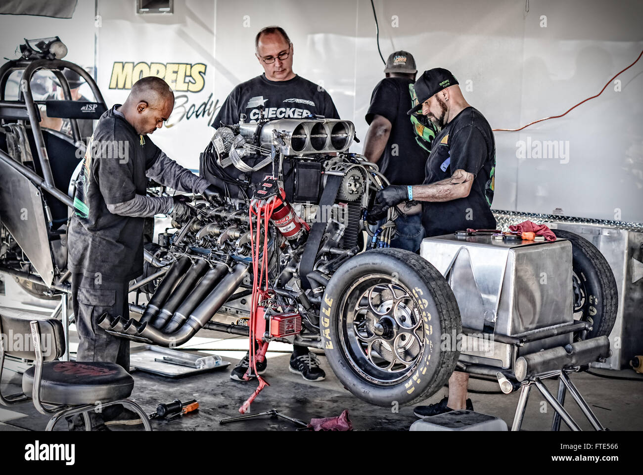 Redding California- Mechanics and crew work on the engine of a drag ...