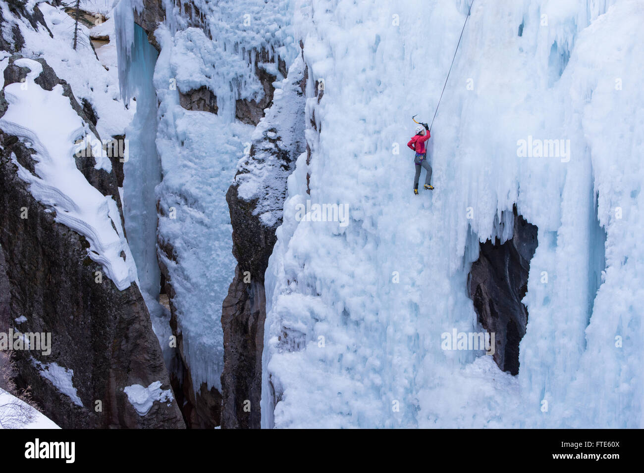Ice climber climbing a route called Pick o' Vic which is rated WI4 in ...