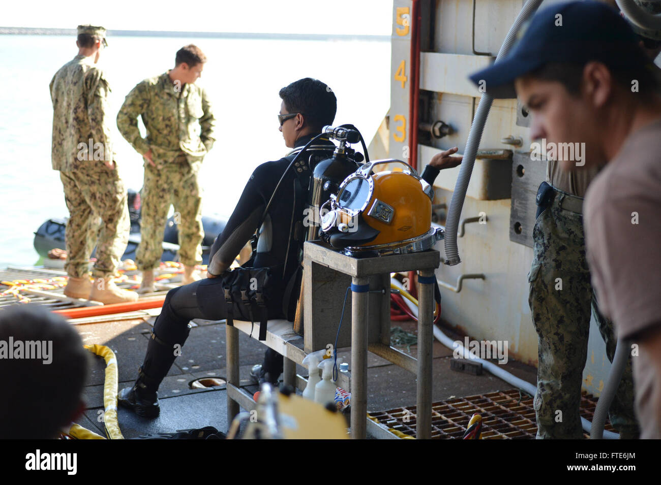 The image shows a diving operation conducted by U.S. Navy personnel ...