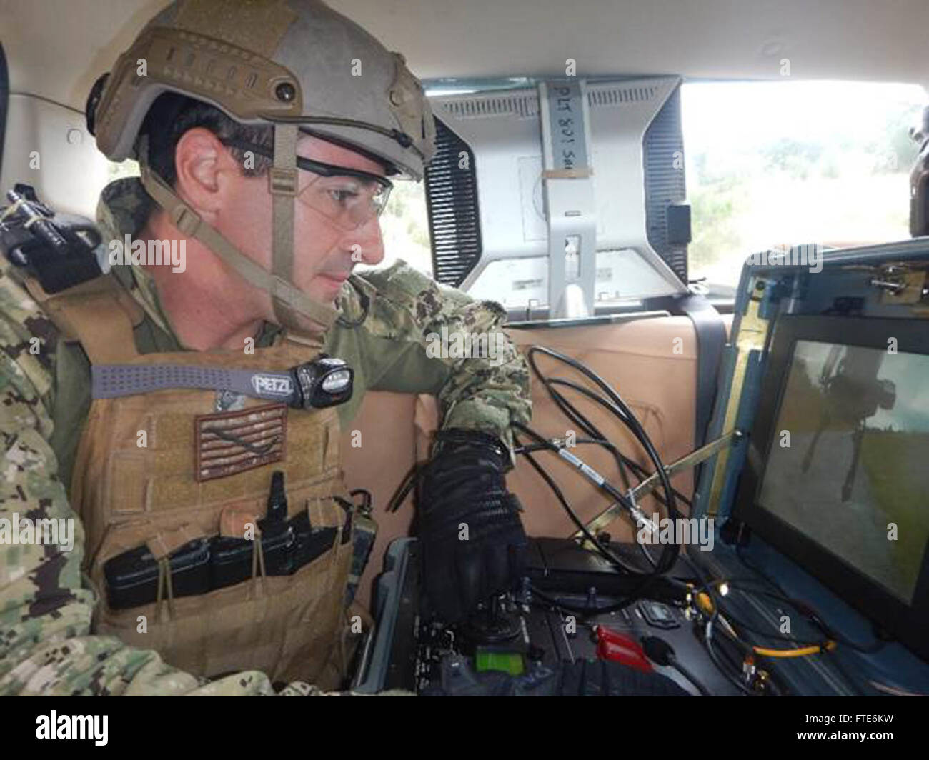 Explosive Ordnance Disposal Technician 2nd Class Daniel Salman operates ...
