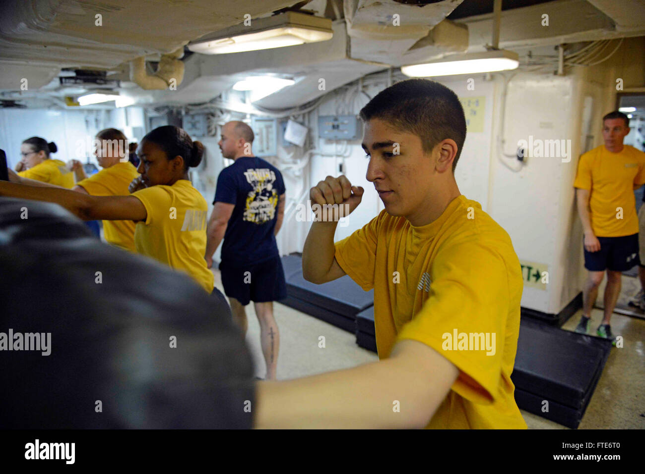The image shows U.S. Navy sailors during security training aboard the ...