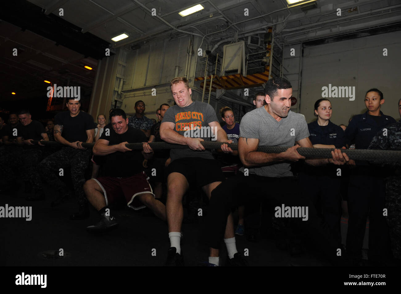 Sailors aboard the USS Nimitz (CVN 68) participate in a tug-of-war ...