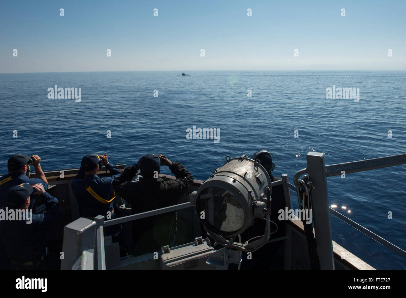 Commander Dave Stoner of the USS Ramage observes the passing of an ...