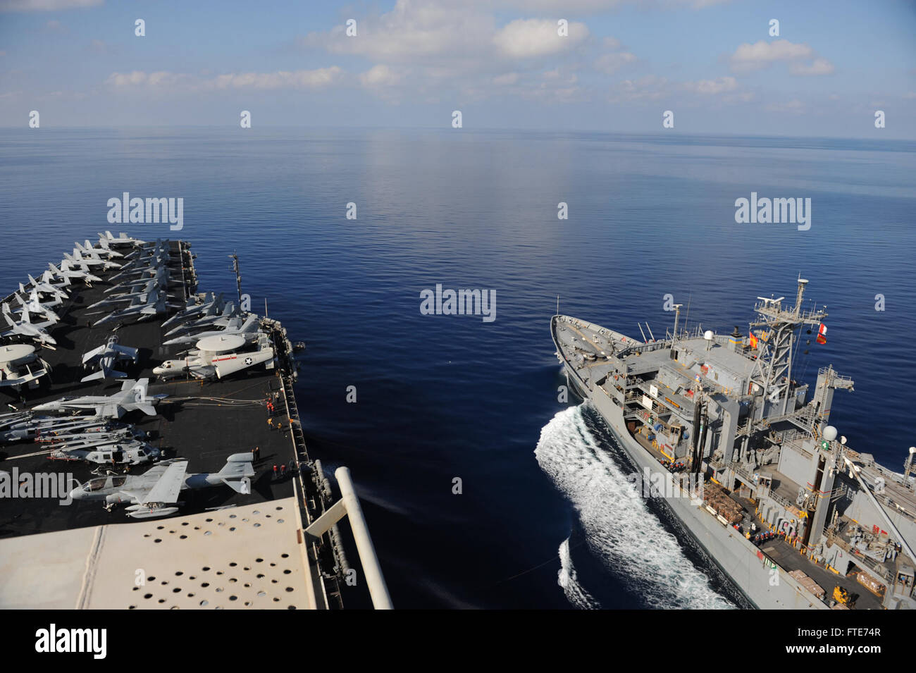 The image shows the USNS Rainier (T-AOE 7), a fast combat support ship ...