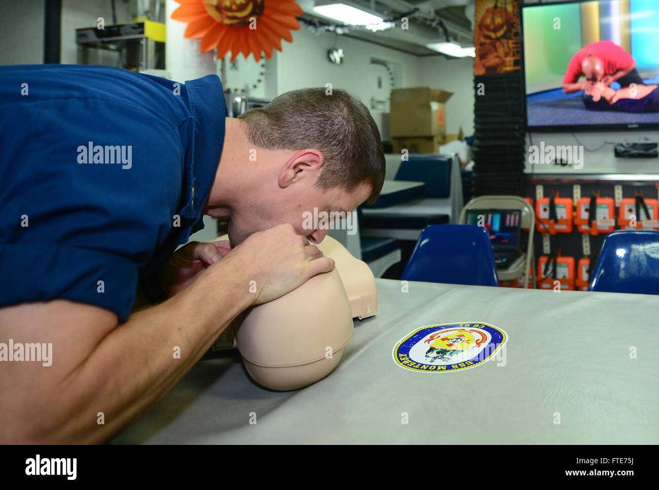 Chief Cryptologic Technician Derek Labbe practices CPR during training ...
