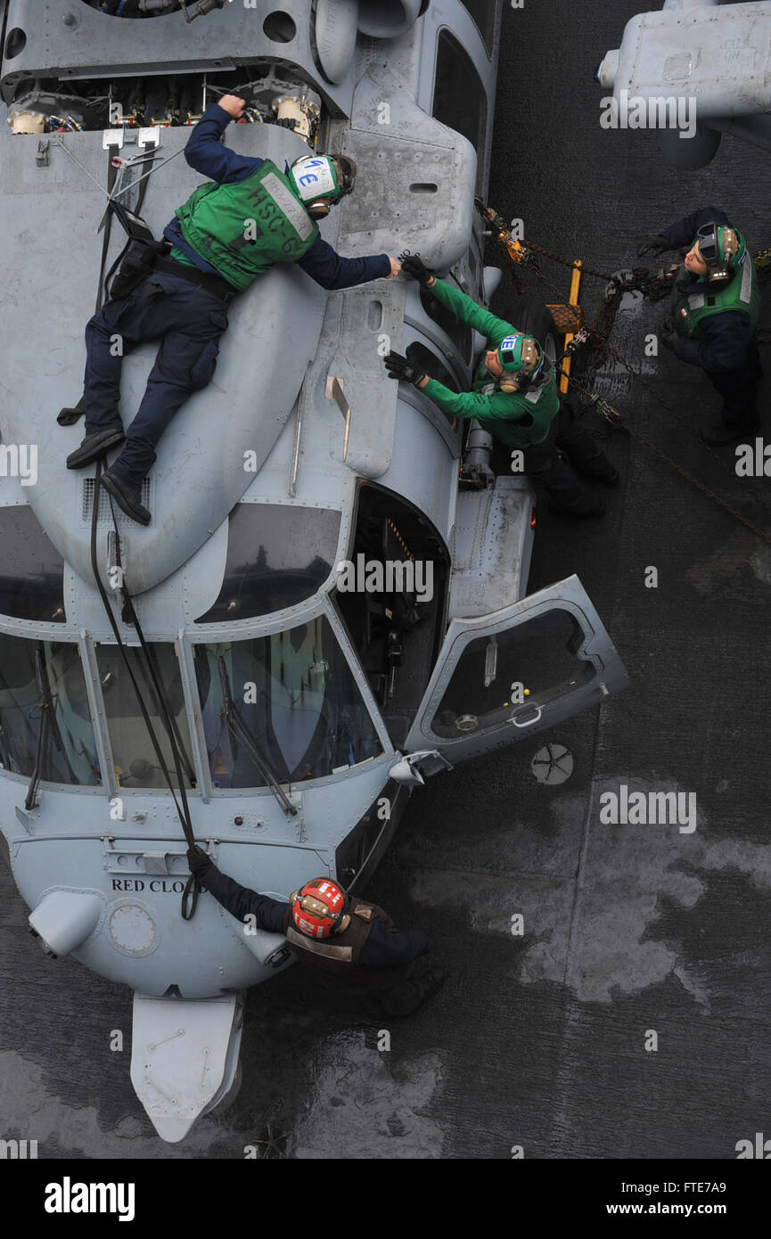 Sailors from Helicopter Sea Combat Squadron (HSC) 6 perform maintenance ...