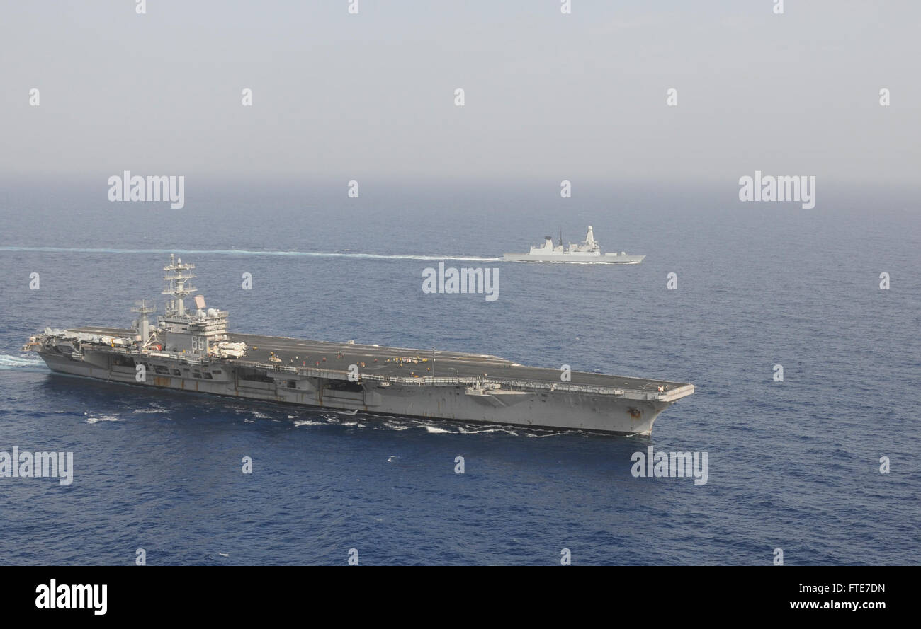 The photograph captures the HMS Dragon (D35), a Daring-class air ...