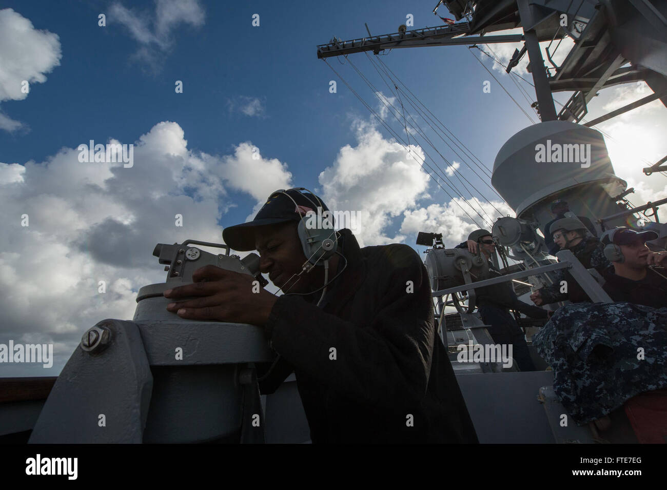 Quartermaster Seaman Byron Frazier monitors a surface contact aboard ...