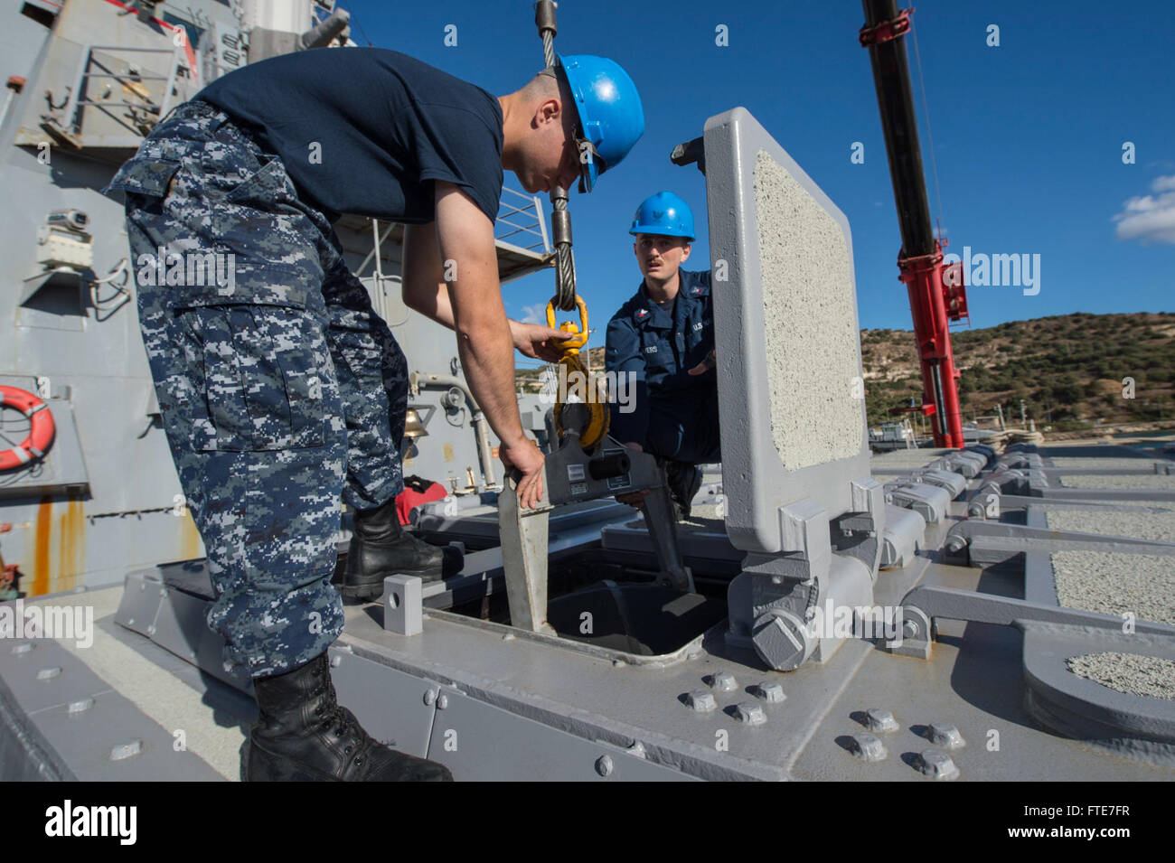 In this U.S. Navy photo, Fire Controlman 2nd Class Jeremiah Avers gives ...