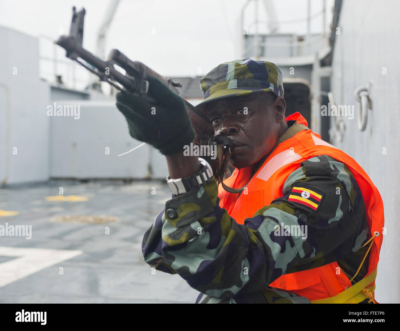 A member of the Uganda People's Defence Force provides security aboard ...