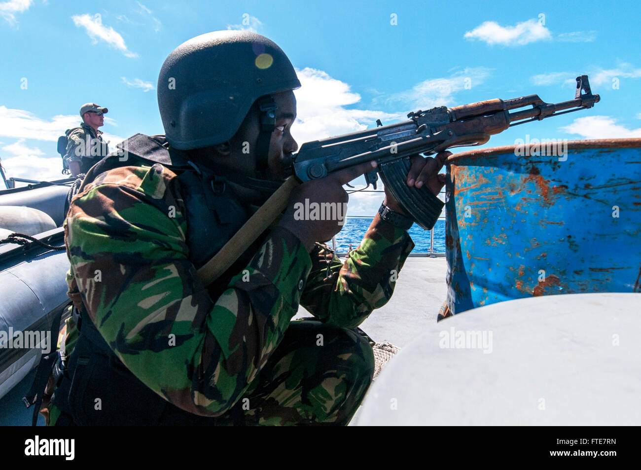 This image shows a Seychelles Coast Guard member securing a target ...