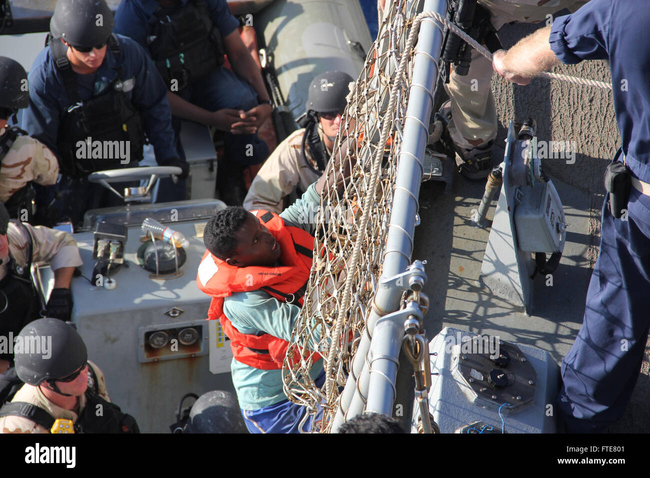 A Somali fisherman, stranded due to engine failure, boards the USS ...