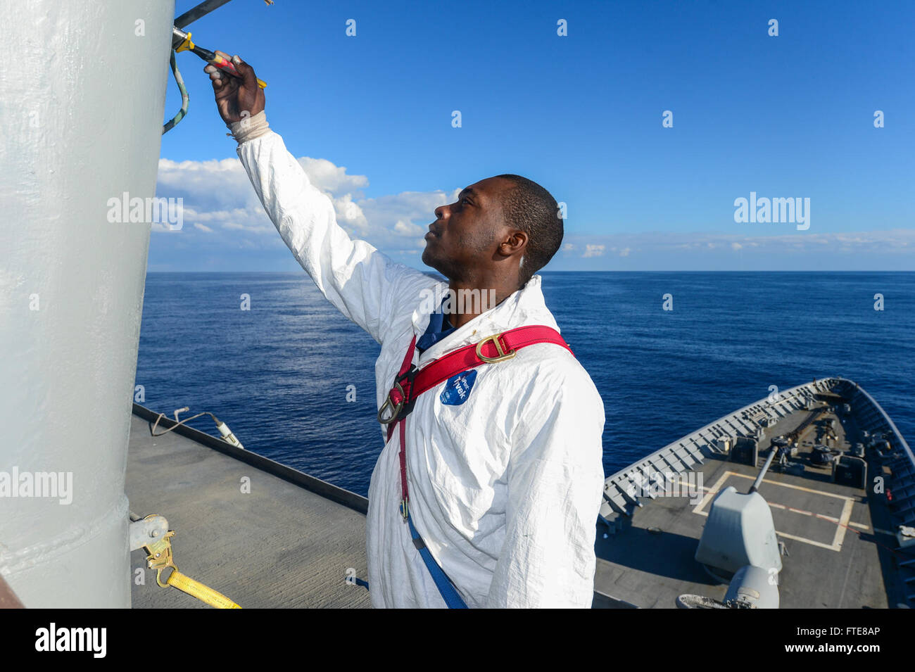 Quartermaster 2nd Class Shaun Carlton is depicted painting outside the ...