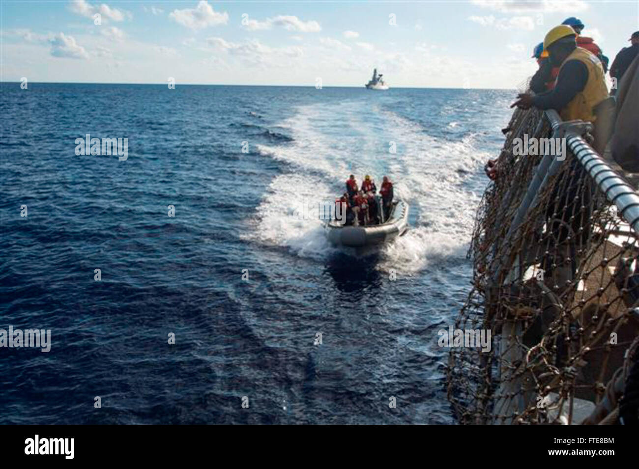 In this image, Sailors return to the USS Ramage (DDG 61) after a ...