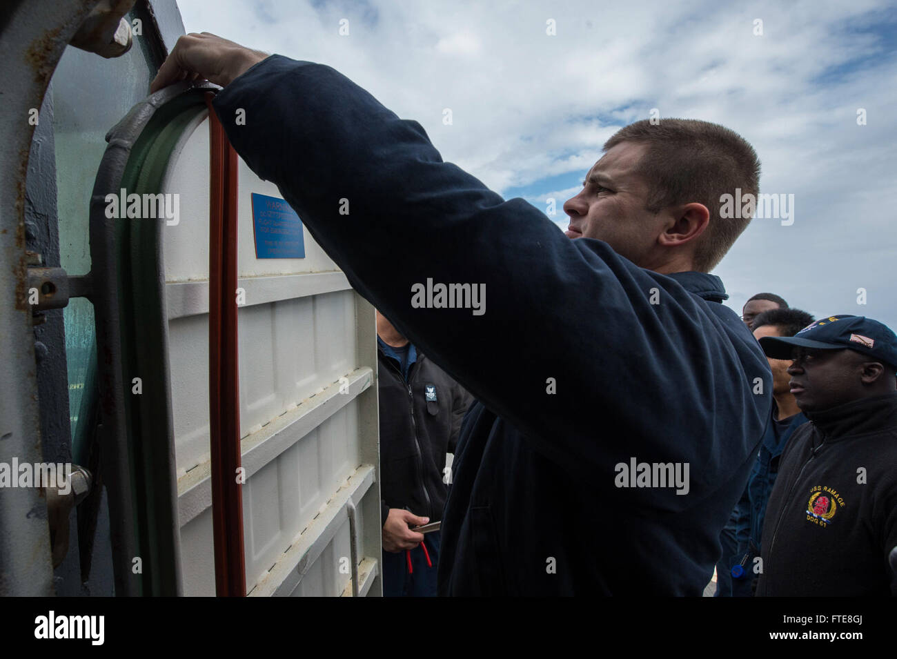 Gas Turbine System Technician 3rd Class Kevin Sayes demonstrates damage ...