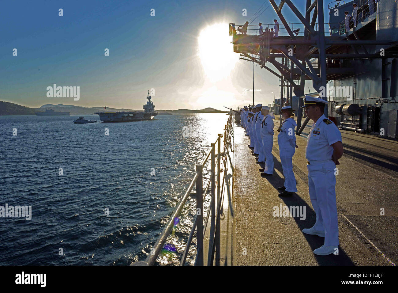 U.S. Navy sailors aboard the USS Mount Whitney (LCC 20) render honors ...