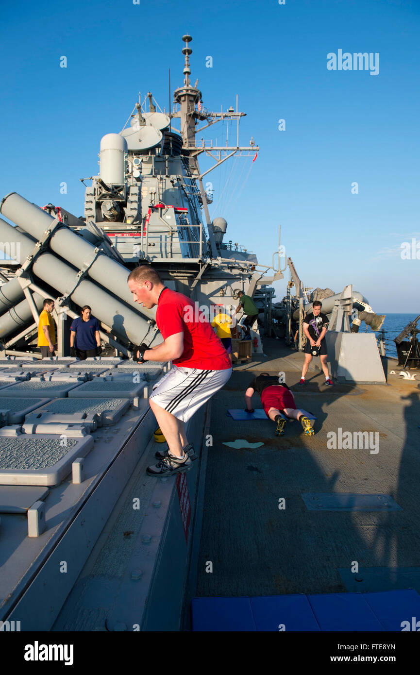 Ens. Michael Crawford performs box jumps on the aft deck missile ...