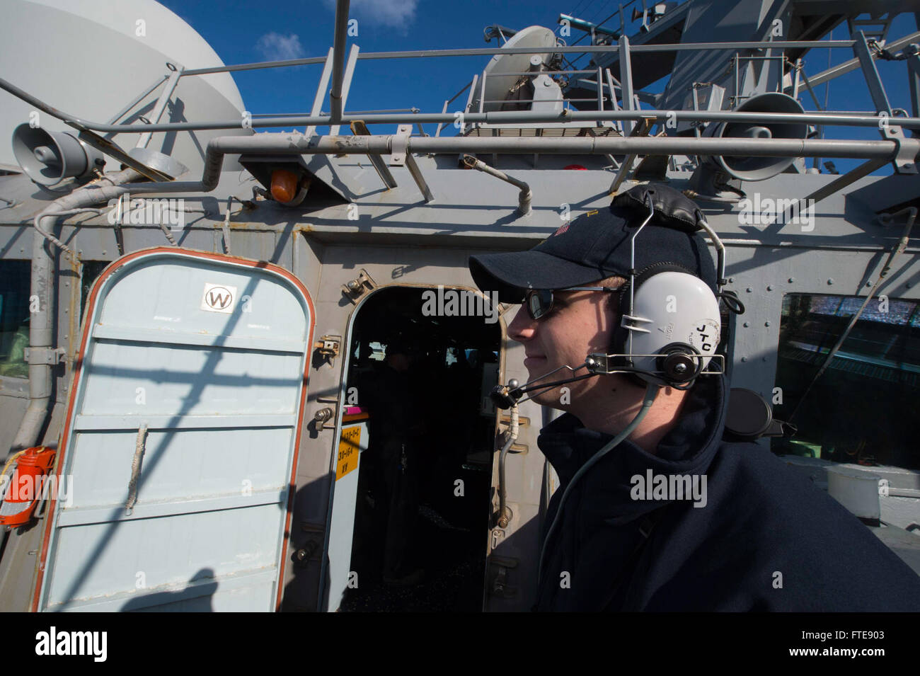 *Seaman Ryan Larson* of the *USS Cole (DDG 67)* stands lookout aboard ...