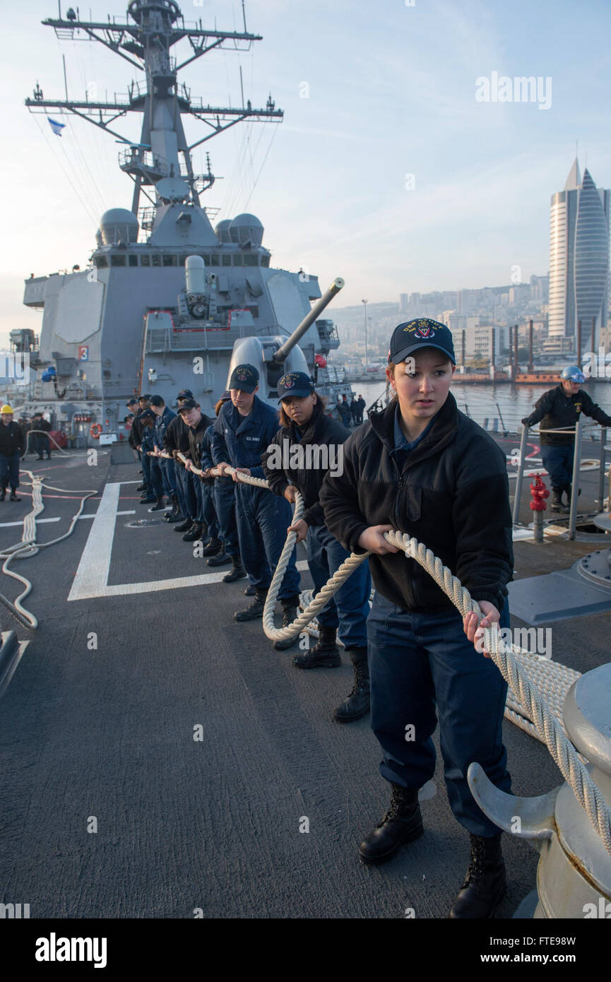 This image captures sailors aboard the USS Stout as they heave mooring ...