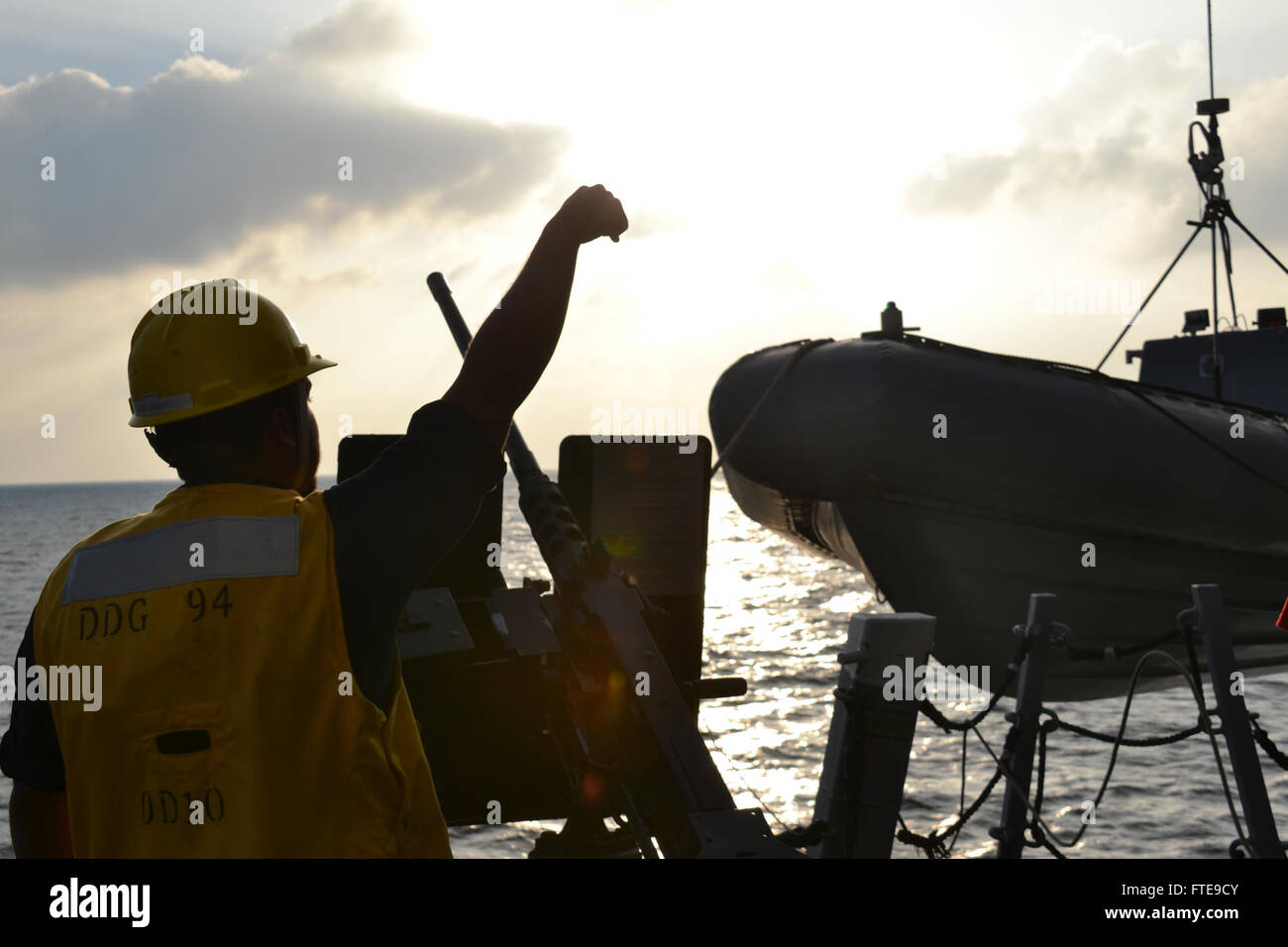 The photo shows Petty Officer in Charge (POIC) SN Steven Guzman giving ...