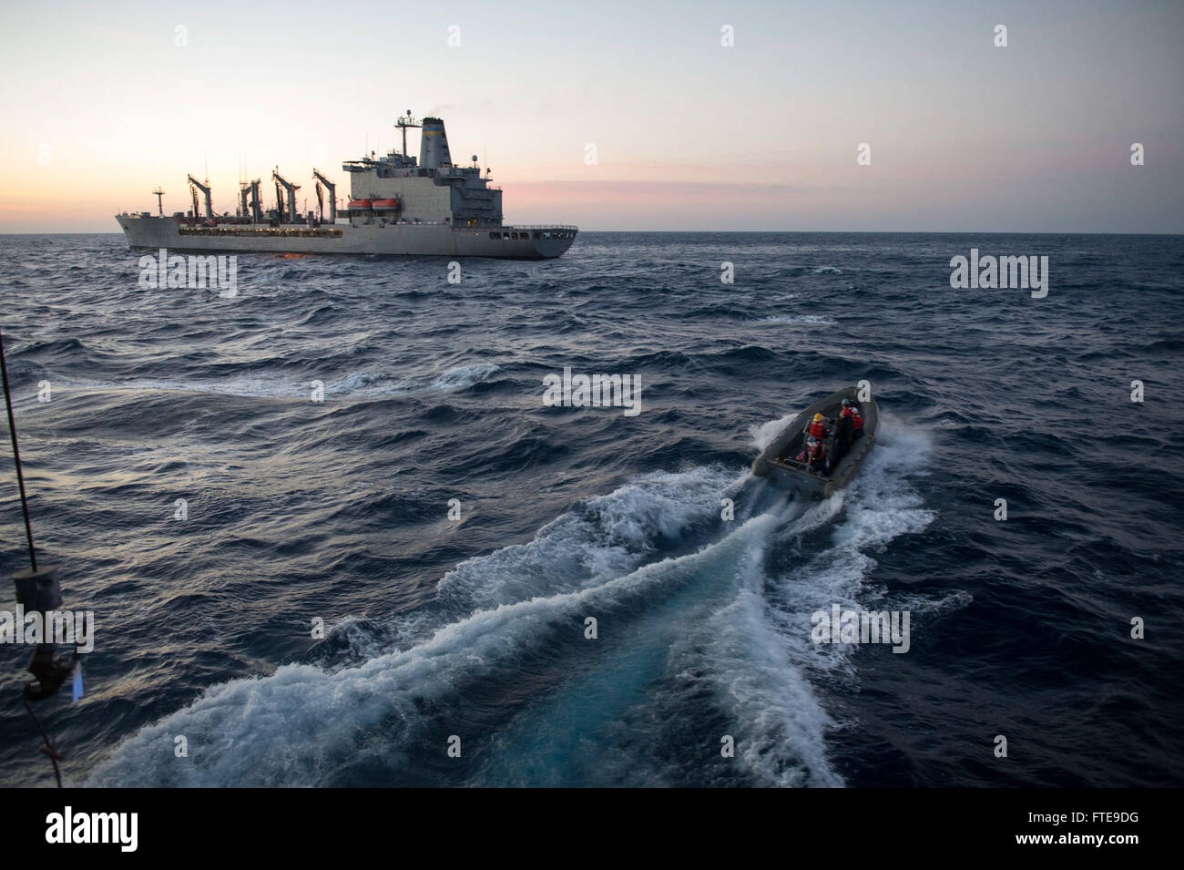 This image shows sailors aboard the USS Stout (DDG 55) maneuvering a ...