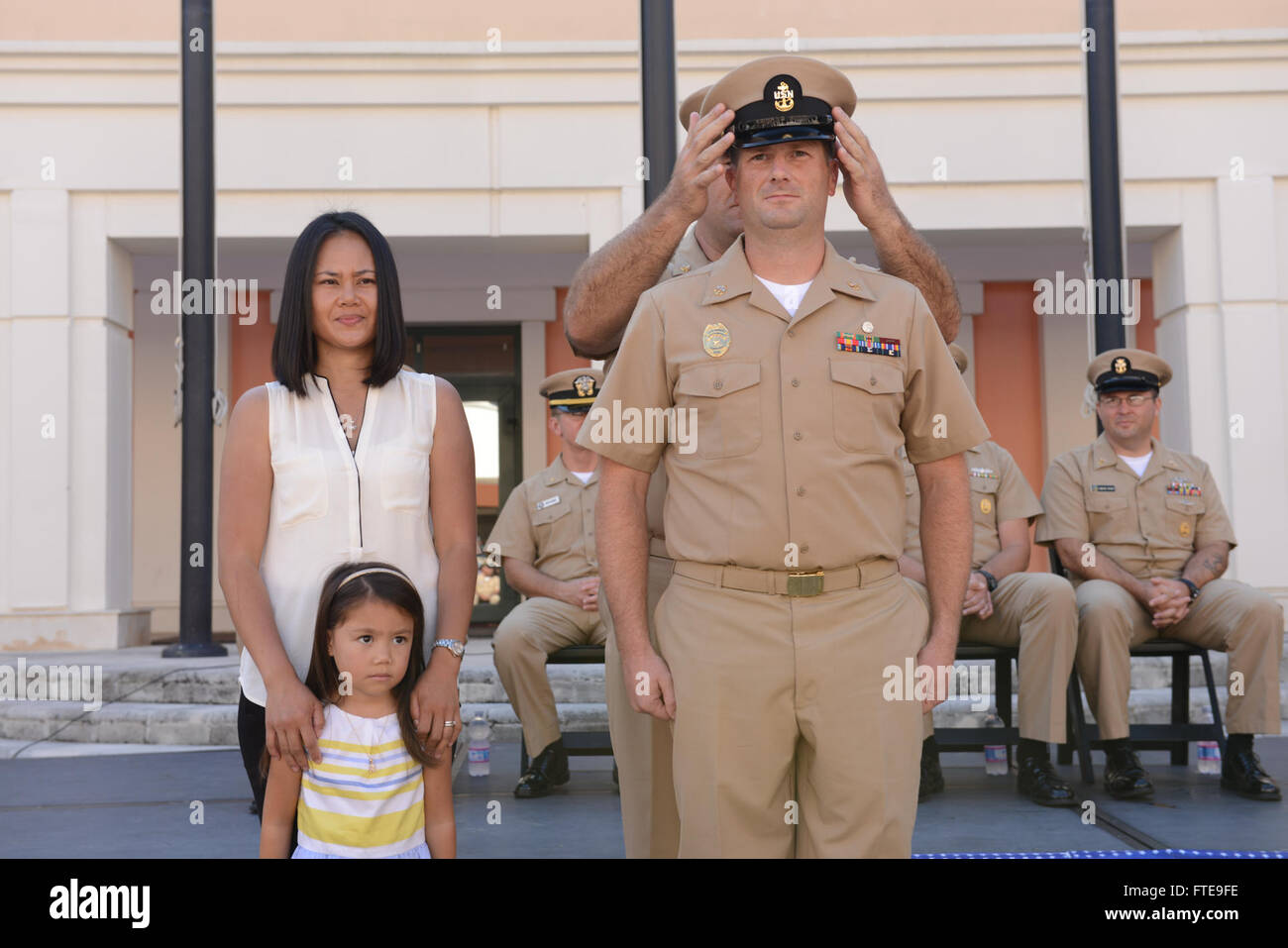 This photograph shows Senior Chief Master-at-Arms Kevin Bell placing a ...