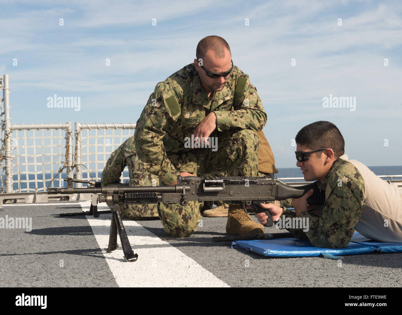 Master-at-Arms 2nd Class Andrew Scott and Gunner's Mate Seaman Enrique ...