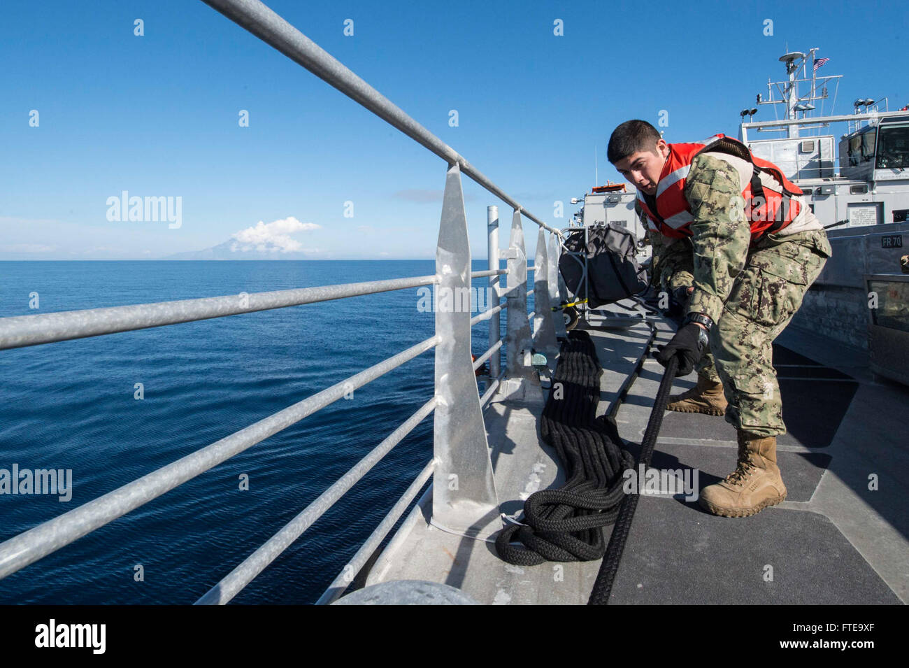 Gunner's Mate Seaman Enrique Ramirez operates aboard the USNS Spearhead ...