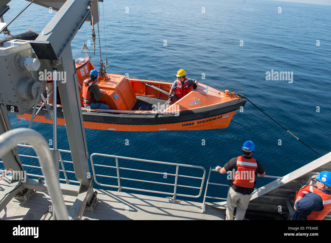 A rescue boat is deployed during a man-overboard drill aboard the *USNS ...