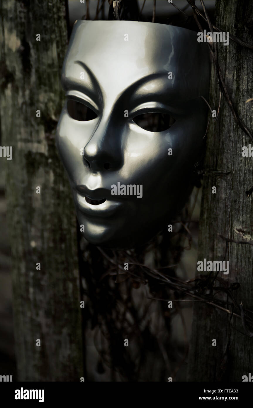 Trapped - Mask on Weathered Fence Stock Photo - Alamy