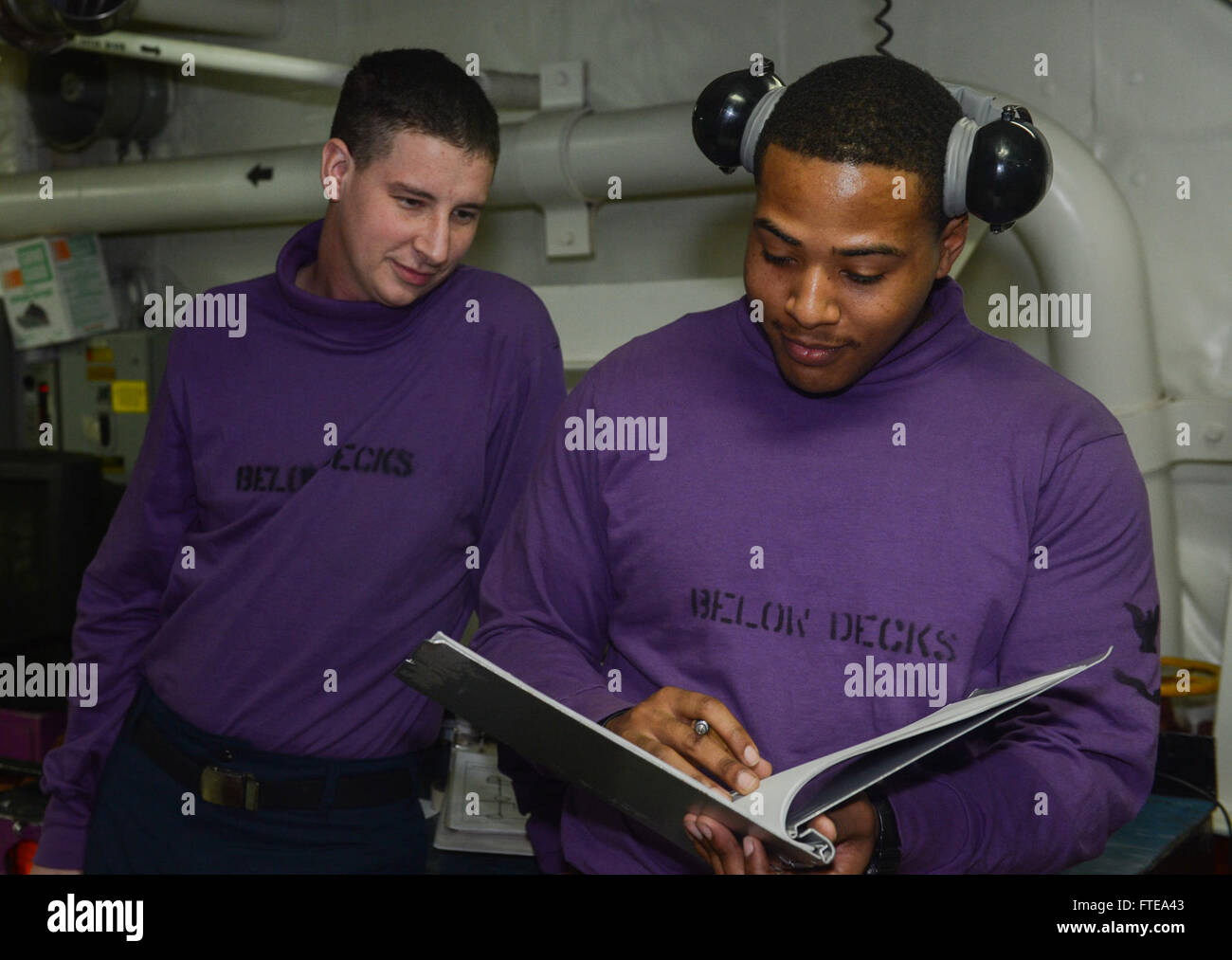 This image captures Aviation Boatswain's Mate 3rd Class James Travis and Aviation Boatswain's ...