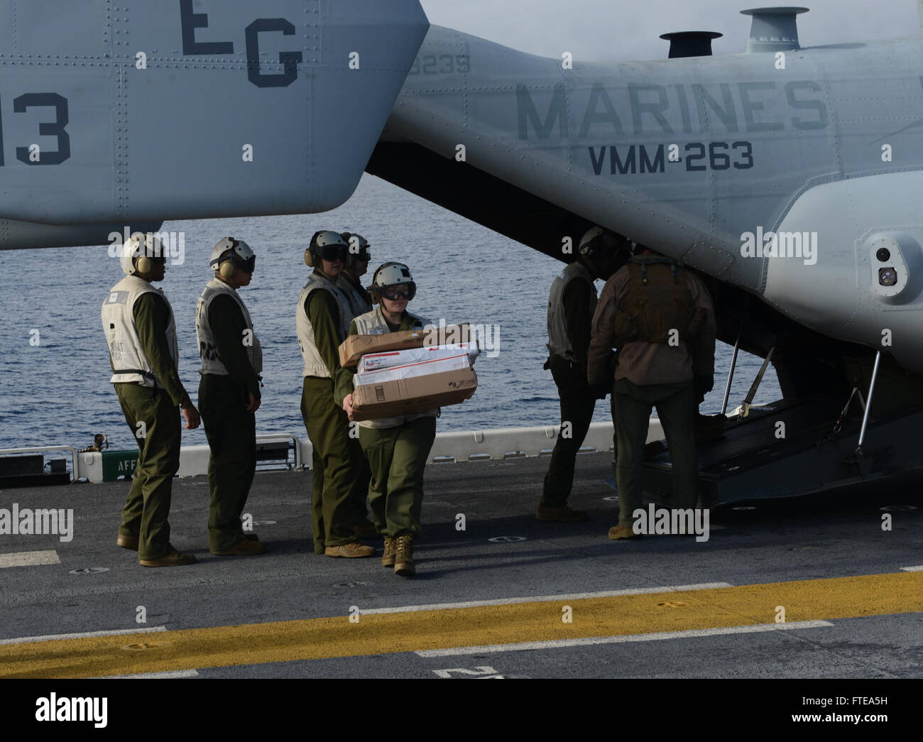 Marines aboard USS Bataan (LHD 5) unload the first mail received on deployment, delivered by an ...