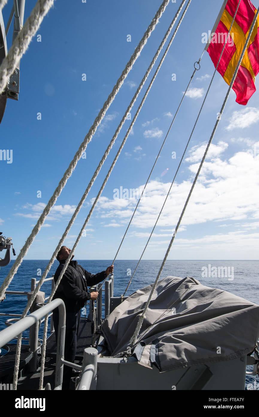 Quartermaster 2nd Class Amun Wilson raises the Romeo flag aboard the ...