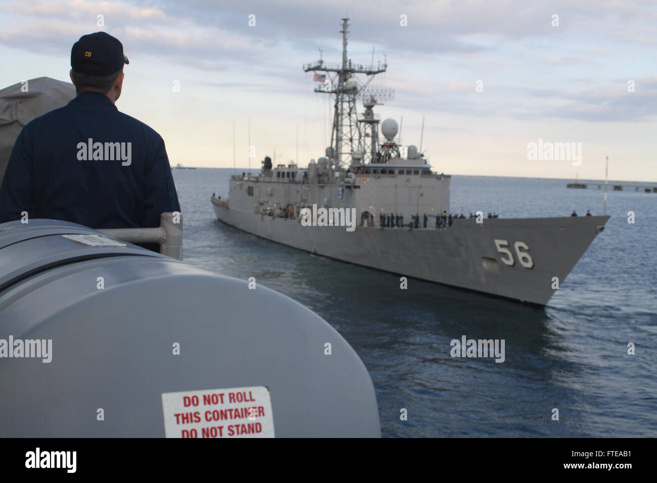 Commander Brad Stallings aboard the USS Elrod observes the USS Simpson ...