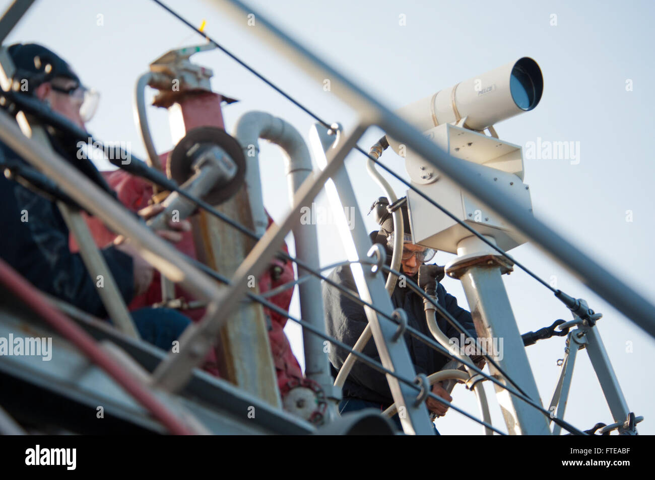This photo shows Boatswain's Mate Seaman Bryan Berrio removing rust and ...