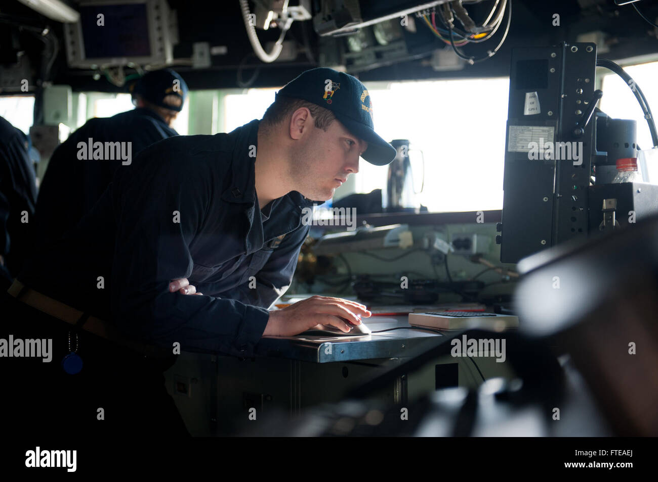 Lt. Brandon Beam aboard USS Arleigh Burke (DDG 51) monitors the ship's ...