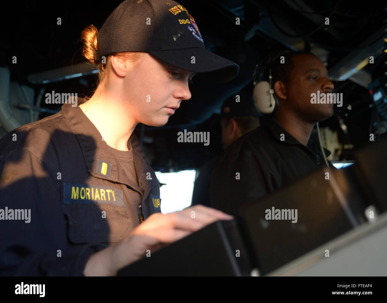 Ensign Bryn Moriarty is pictured operating the SPS-73 navigational ...