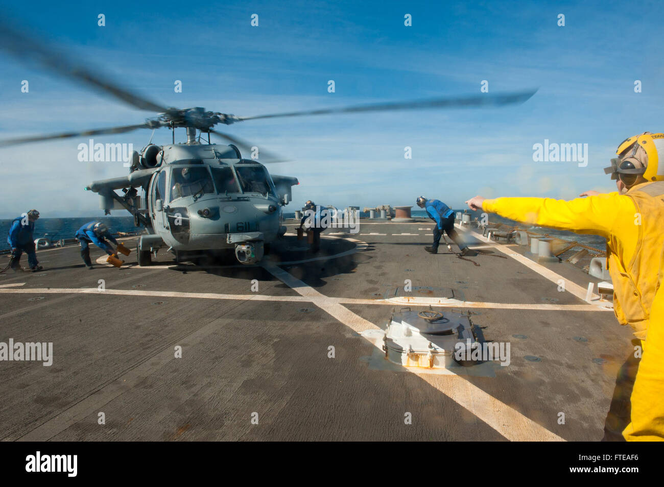 This image shows sailors aboard the USS Arleigh Burke (DDG 51) securing ...