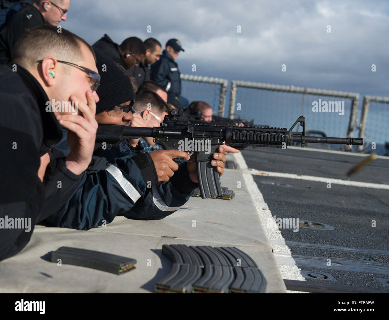 Sailors aboard the USS Simpson (FFG 56) engage in a live fire exercise ...