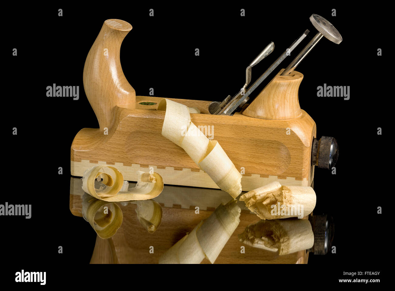 Beautiful wood plane with shavings on a black surface Stock Photo - Alamy